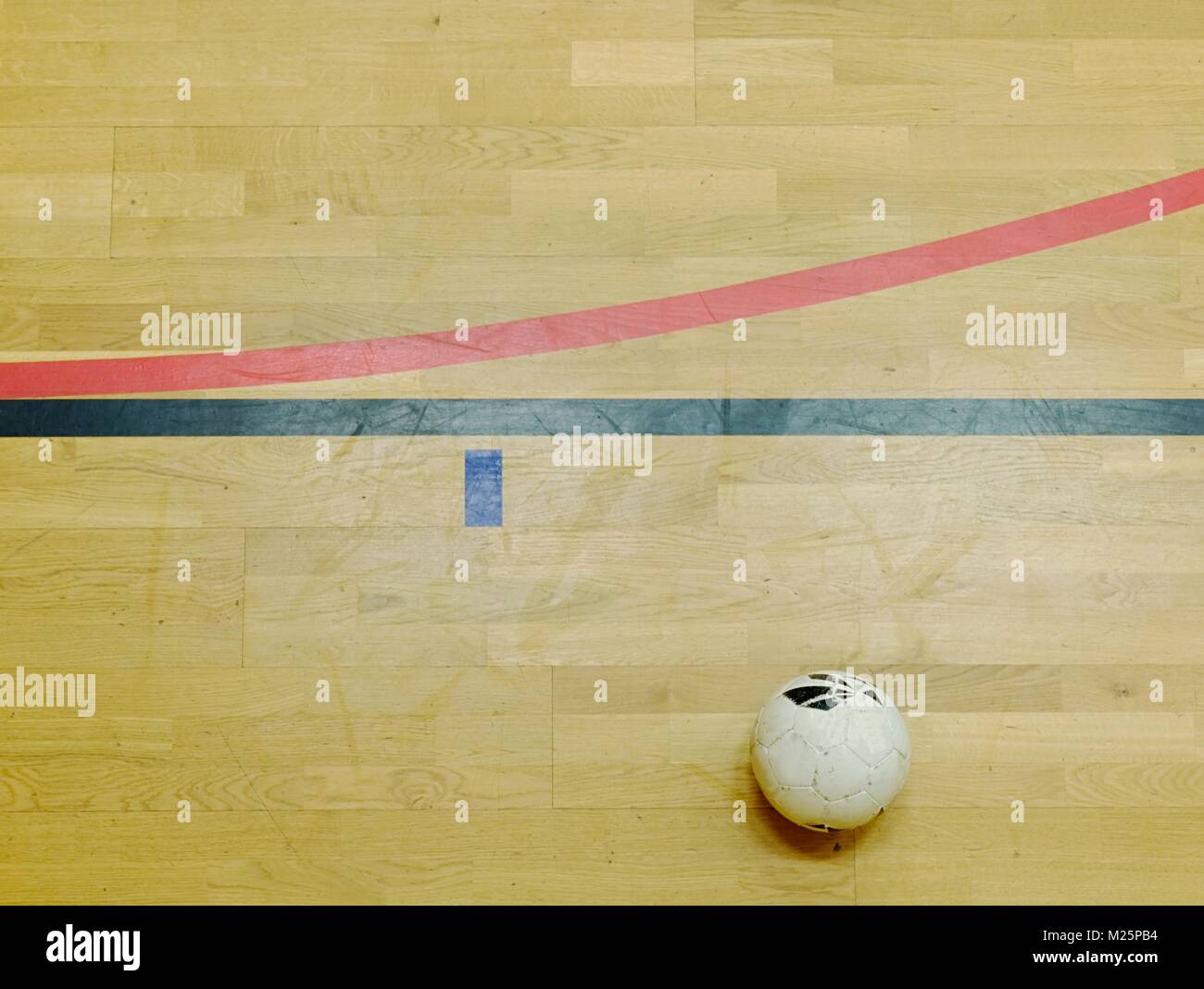 Futsal ball and red and black lines on hardwood sporting floor. Renewal ...