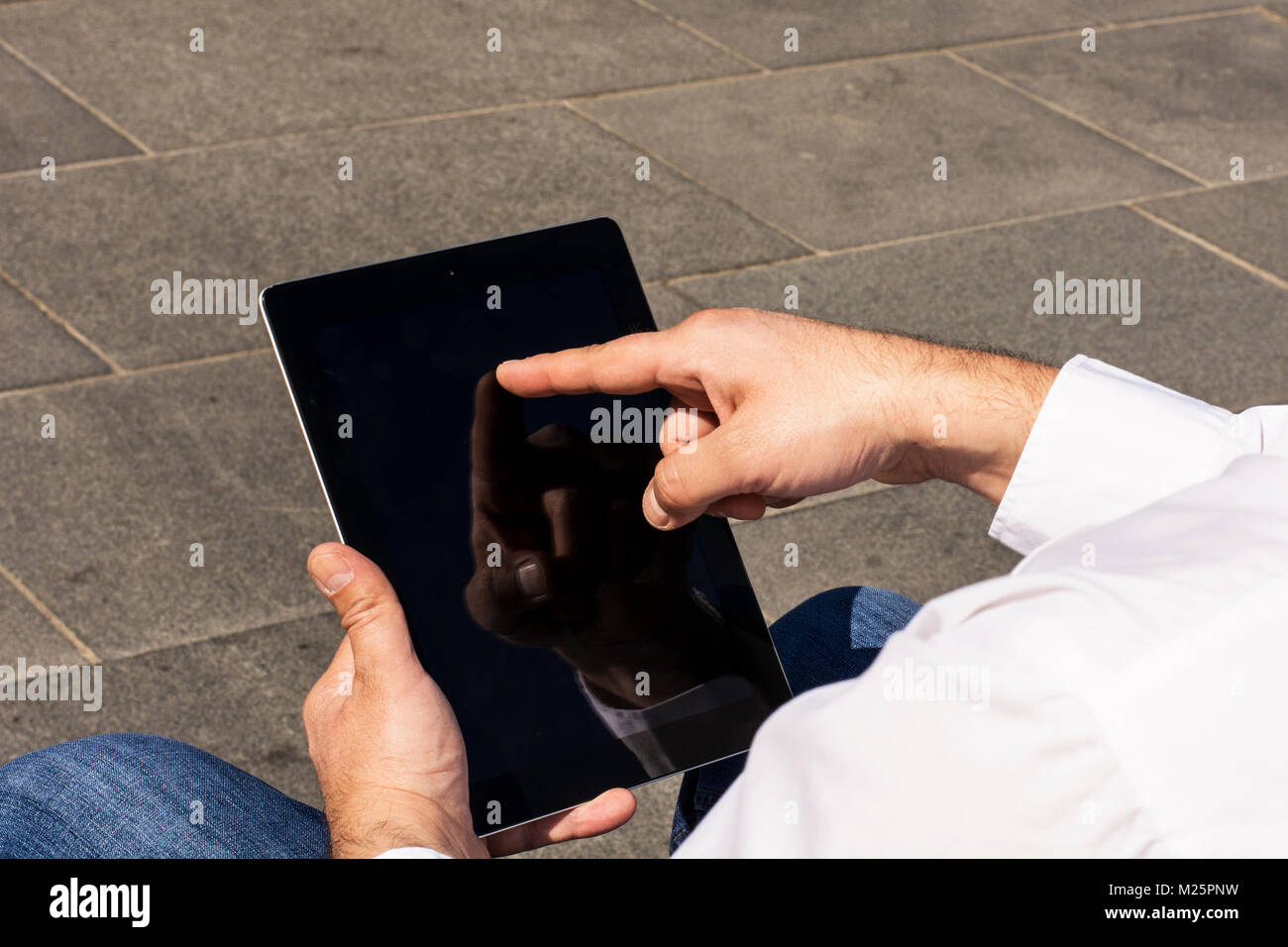 Man pointing with his finger on screen of digital tablet Stock Photo ...