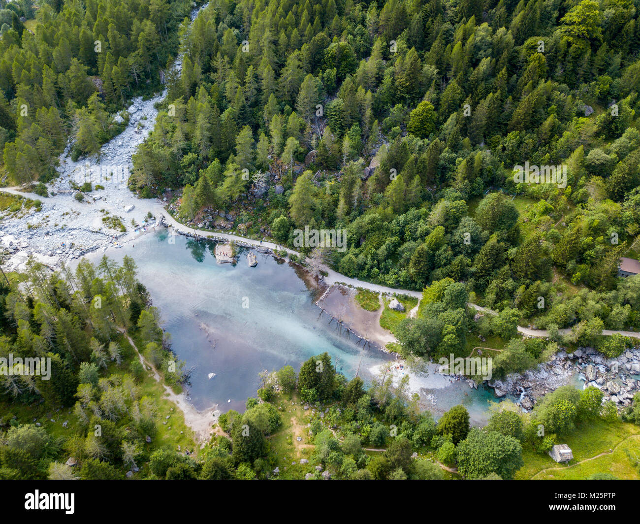 Aerial view of a lake in Val di Mello, a green valley surrounded by ...