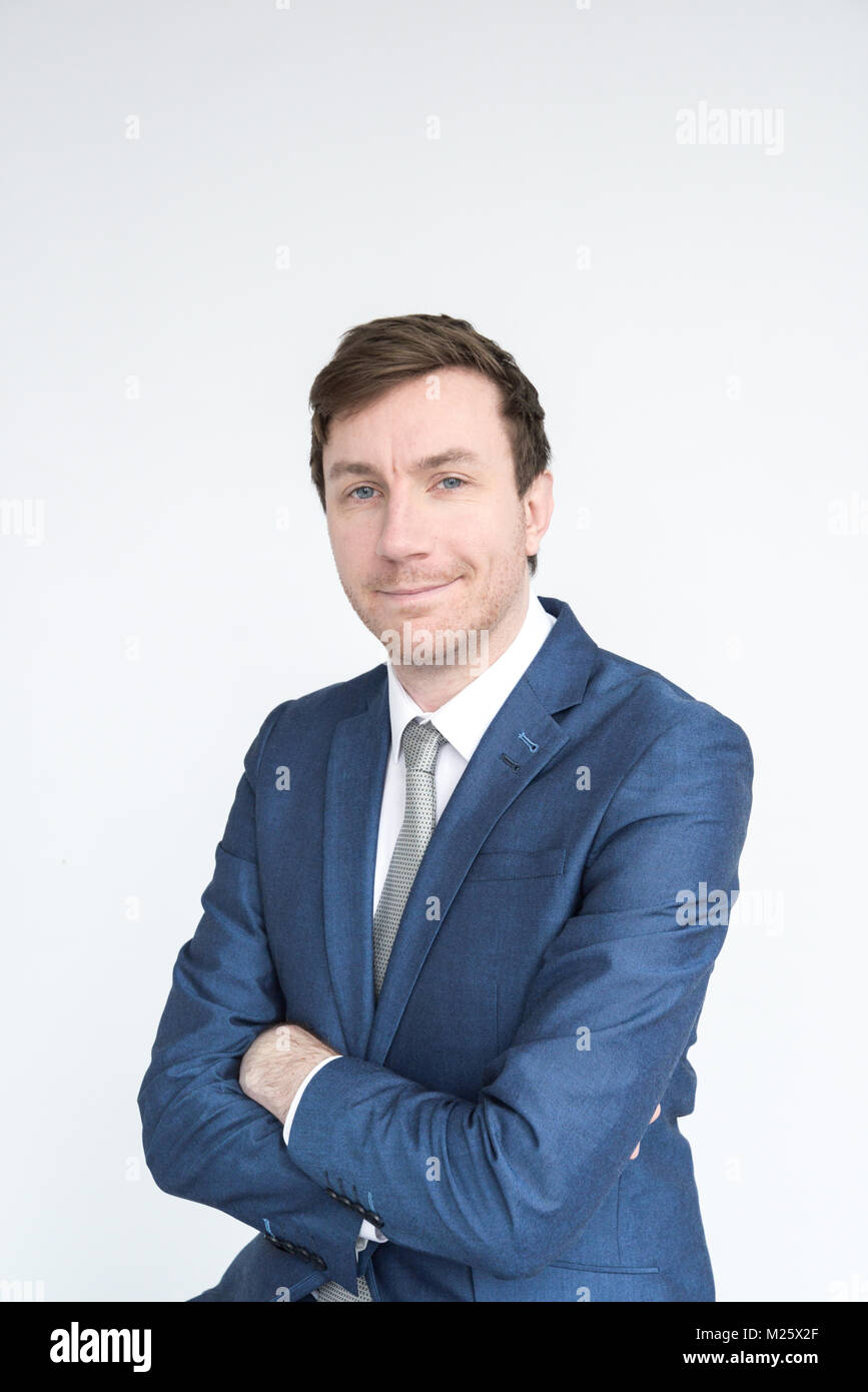 Portrait of a smartly dressed smiling man looking into camera.Isolated ...