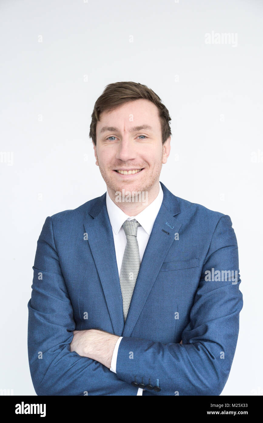 Portrait of a smartly dressed smiling man looking into camera.Isolated ...