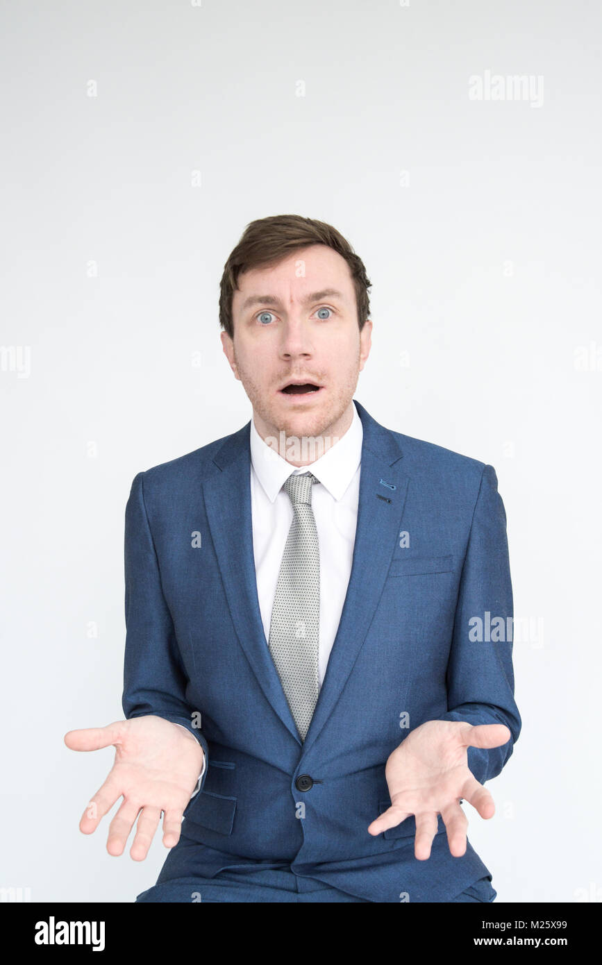 Portrait of a well dressed man with a look of surprise or shock on his ...