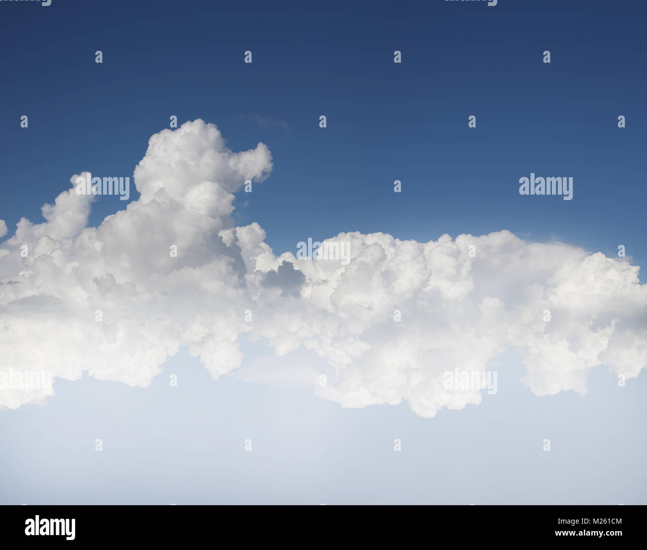 Fluffy white clouds in a blue sky Stock Photo - Alamy