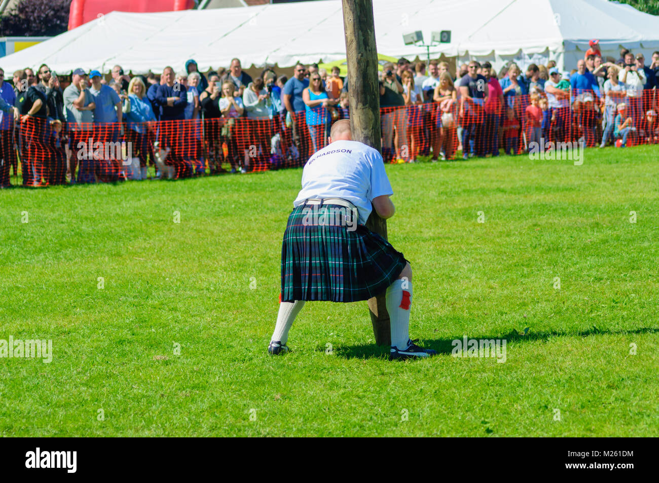 Male prepares to compete in tossing the caber competition at the ...