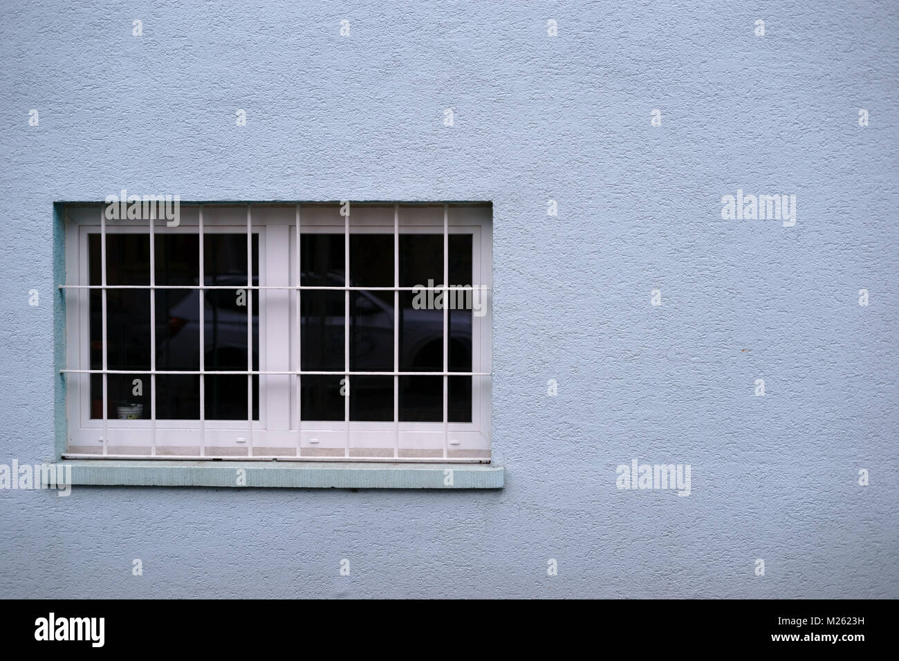 The detail of a lattice window on the plastered house facade Stock ...