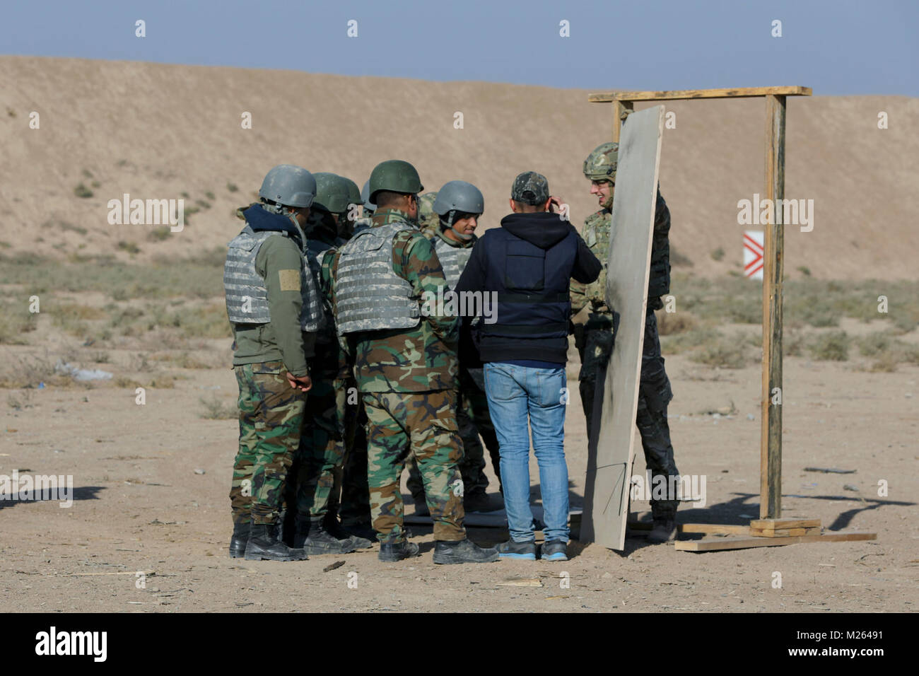 Iraqi Security Forces member review a door post- qualification with a ...