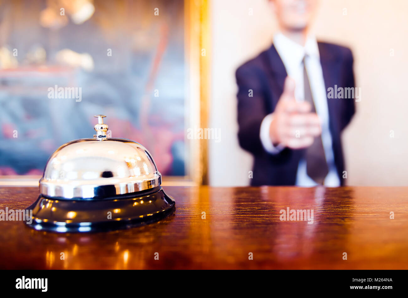 Hotel reception bell and receptionist greeting handshake Stock Photo ...