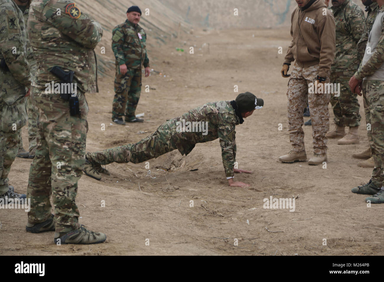An Iraqi soldier demonstrates how to do a proper push up during the ...
