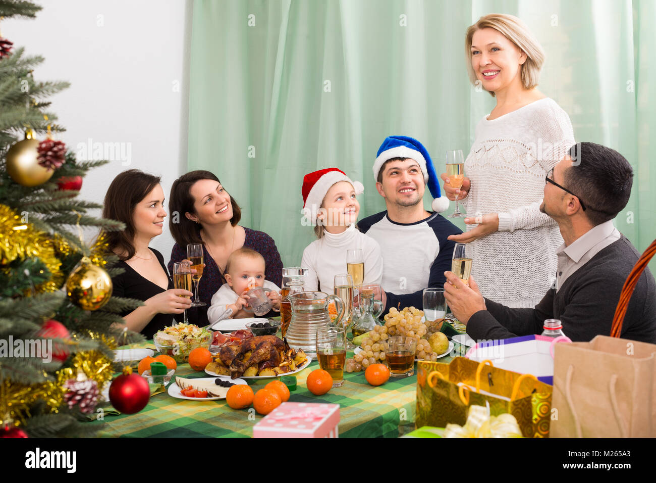 Happy family with children celebrates Christmas at table in home Stock ...