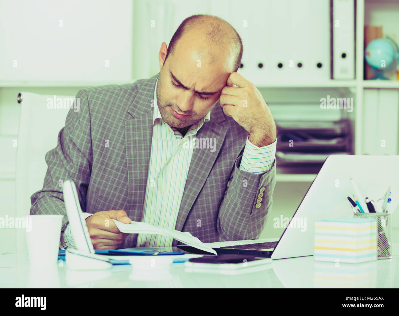Sad businessman thinking about work in the modern office Stock Photo ...