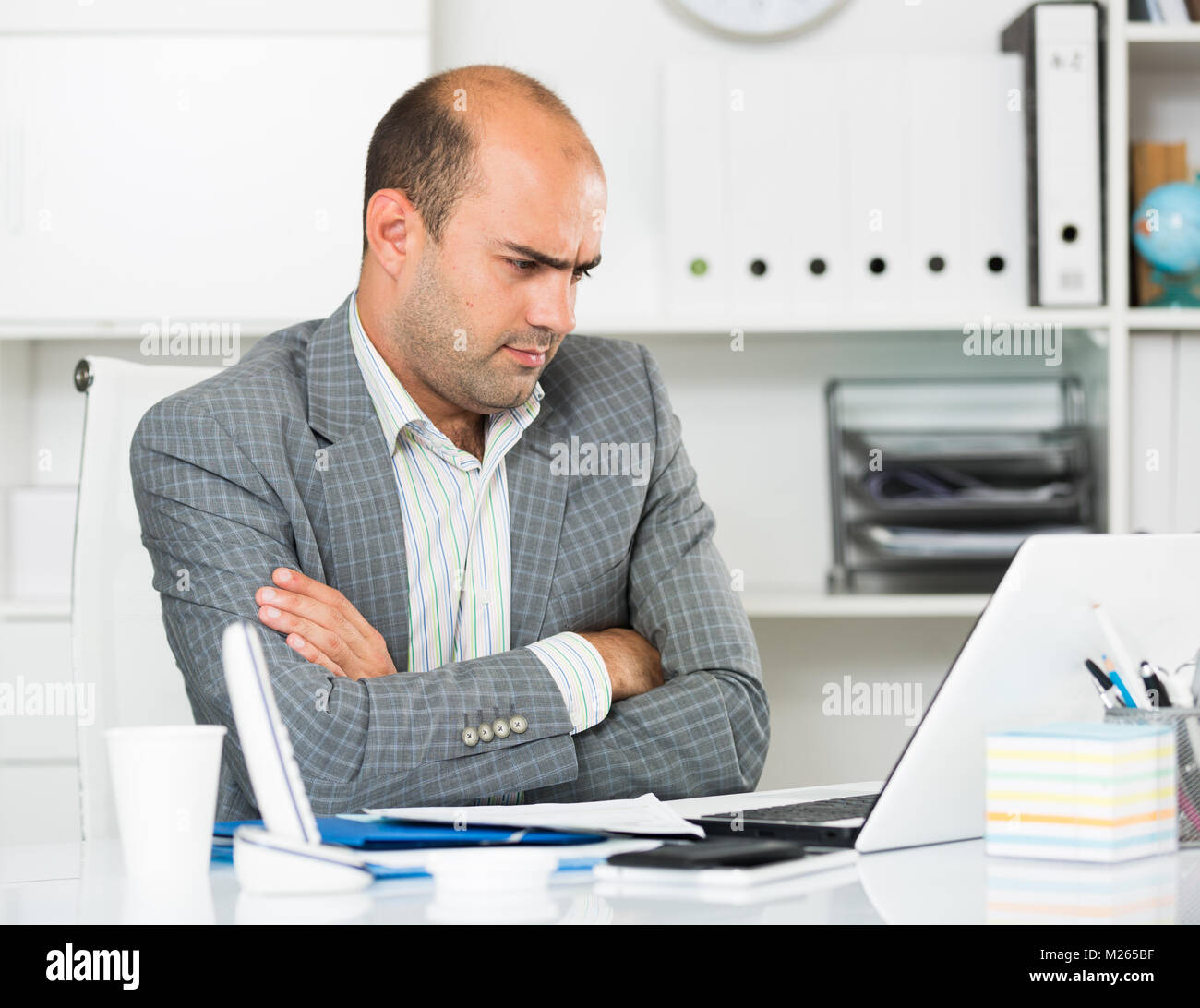 Sad businessman thinking about work in the modern office Stock Photo ...