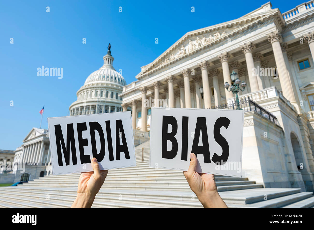 Hands of protestors holding up signs calling attention to media bias in ...