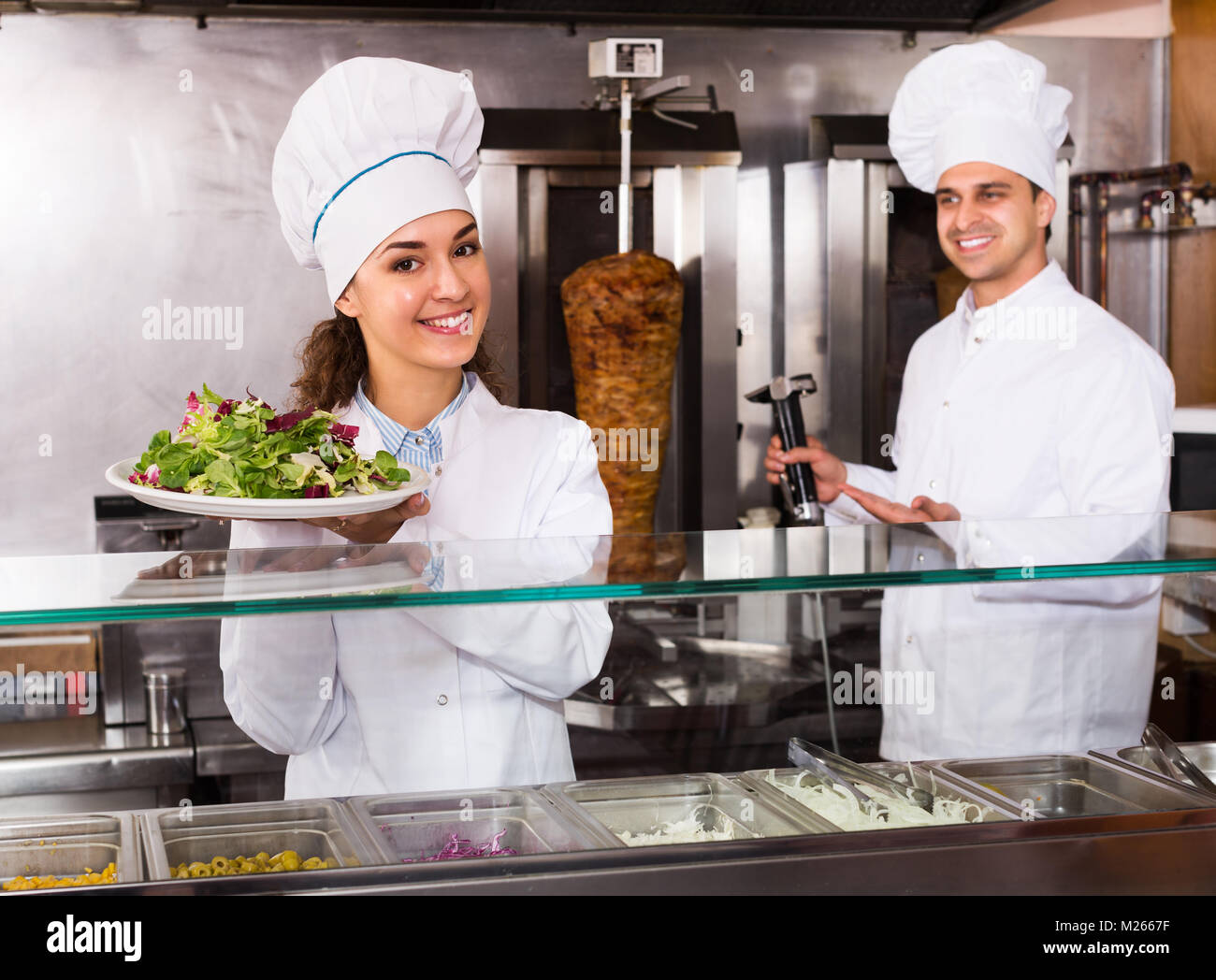 Young cafe staff posing at kebab counter and smiling Stock Photo - Alamy