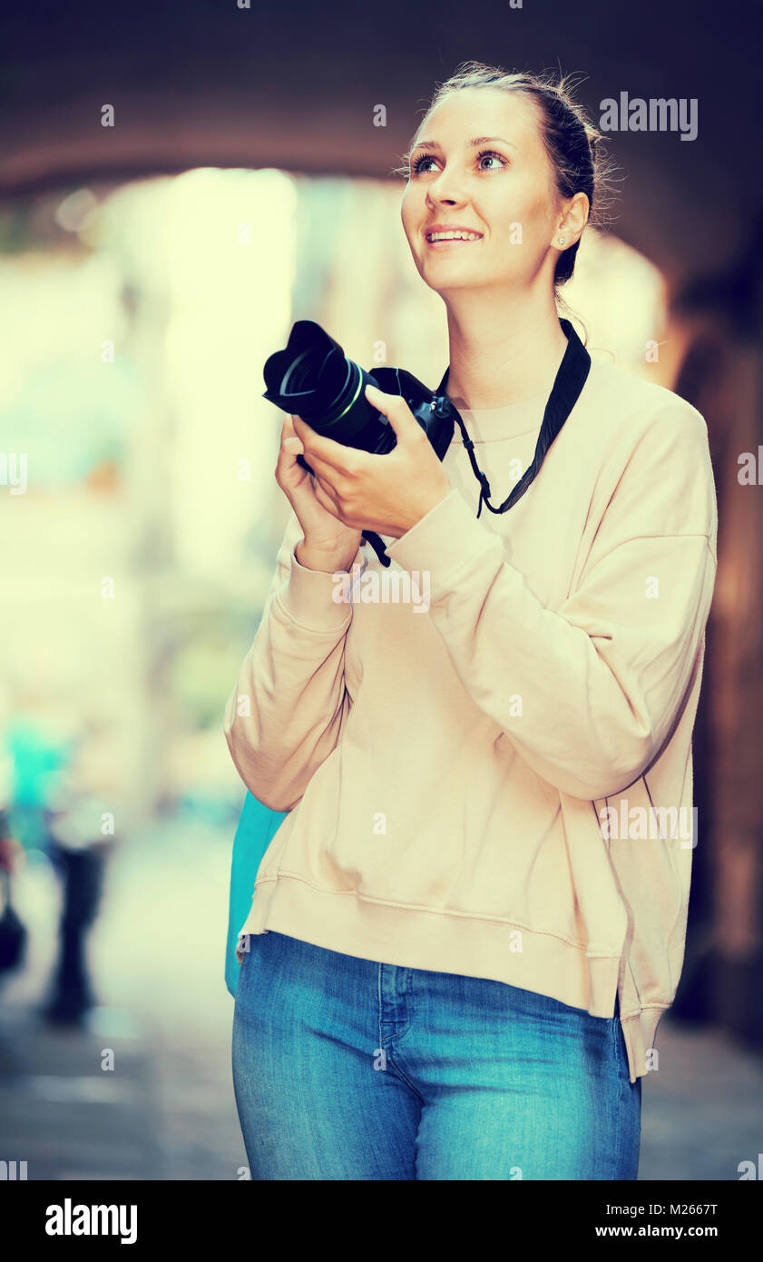 portraitl woman taking picture with camera in the town Stock Photo - Alamy