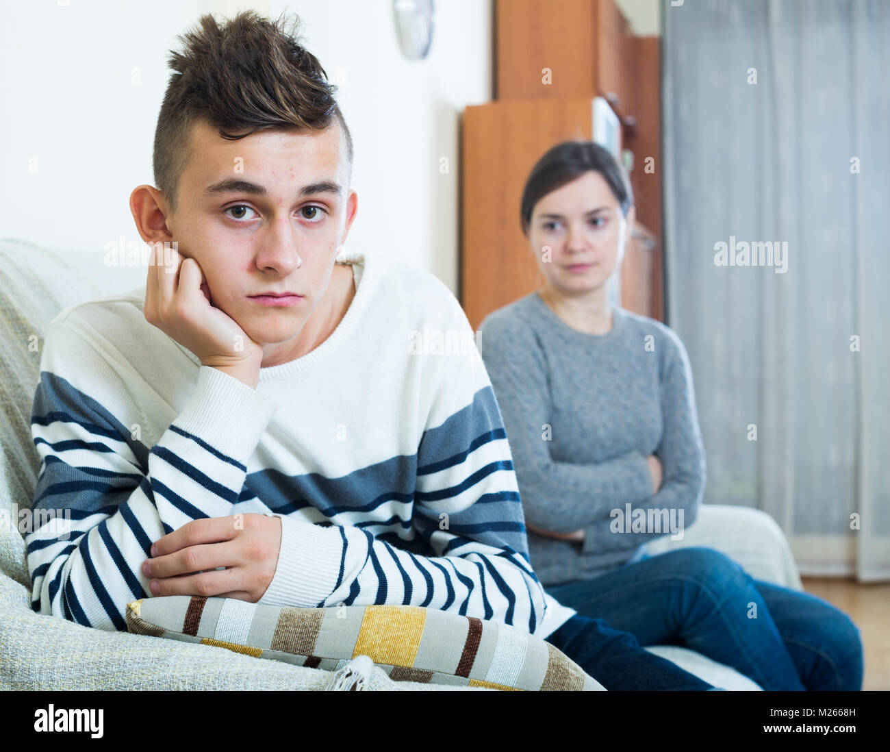 Upset mother and angry son arguing in domestic interior Stock Photo - Alamy
