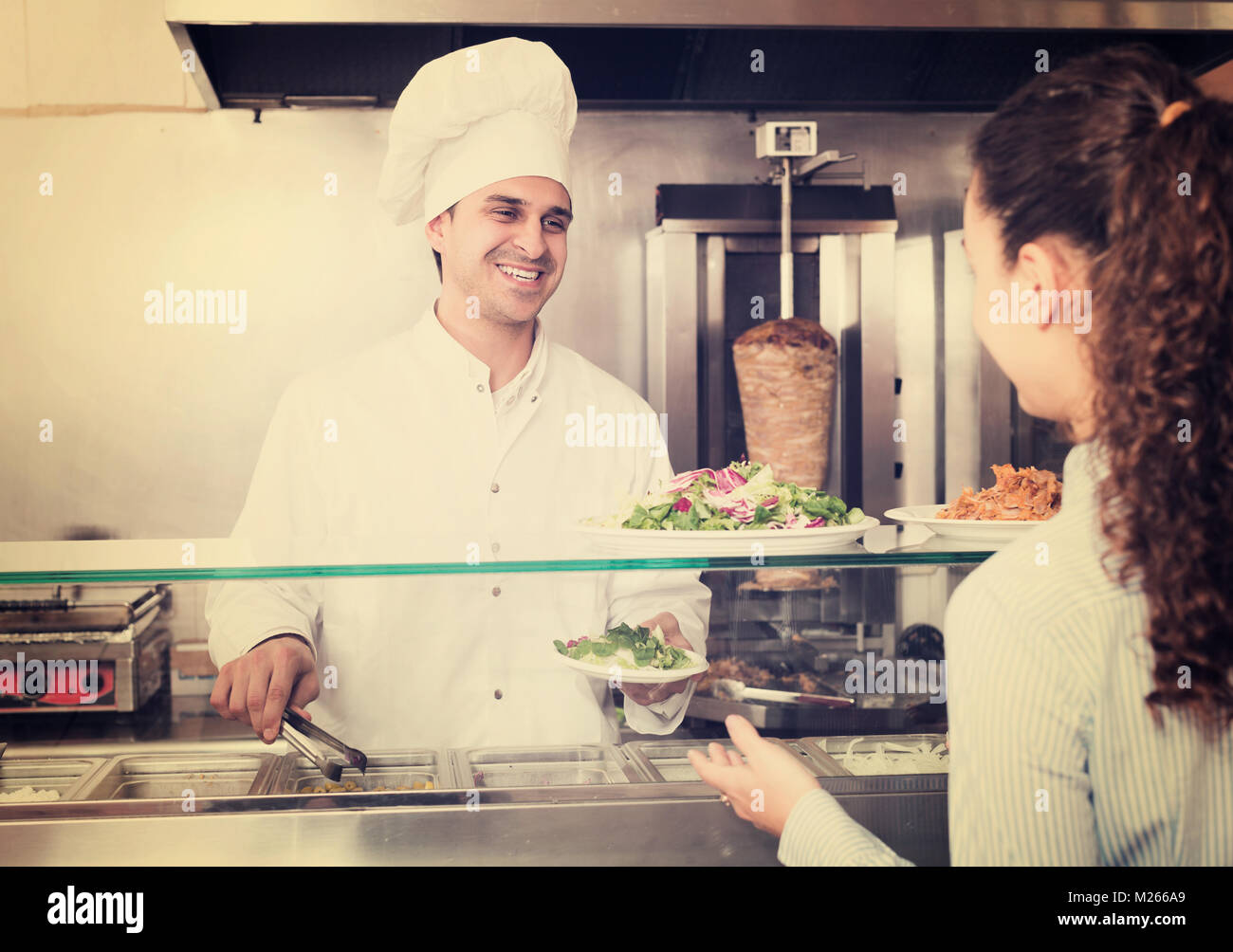 Young girl buying kebab and salad at counter Stock Photo - Alamy