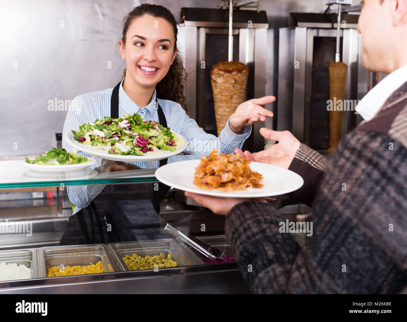Happy adult restaurant staff posing at kebab counter and smiling Stock ...