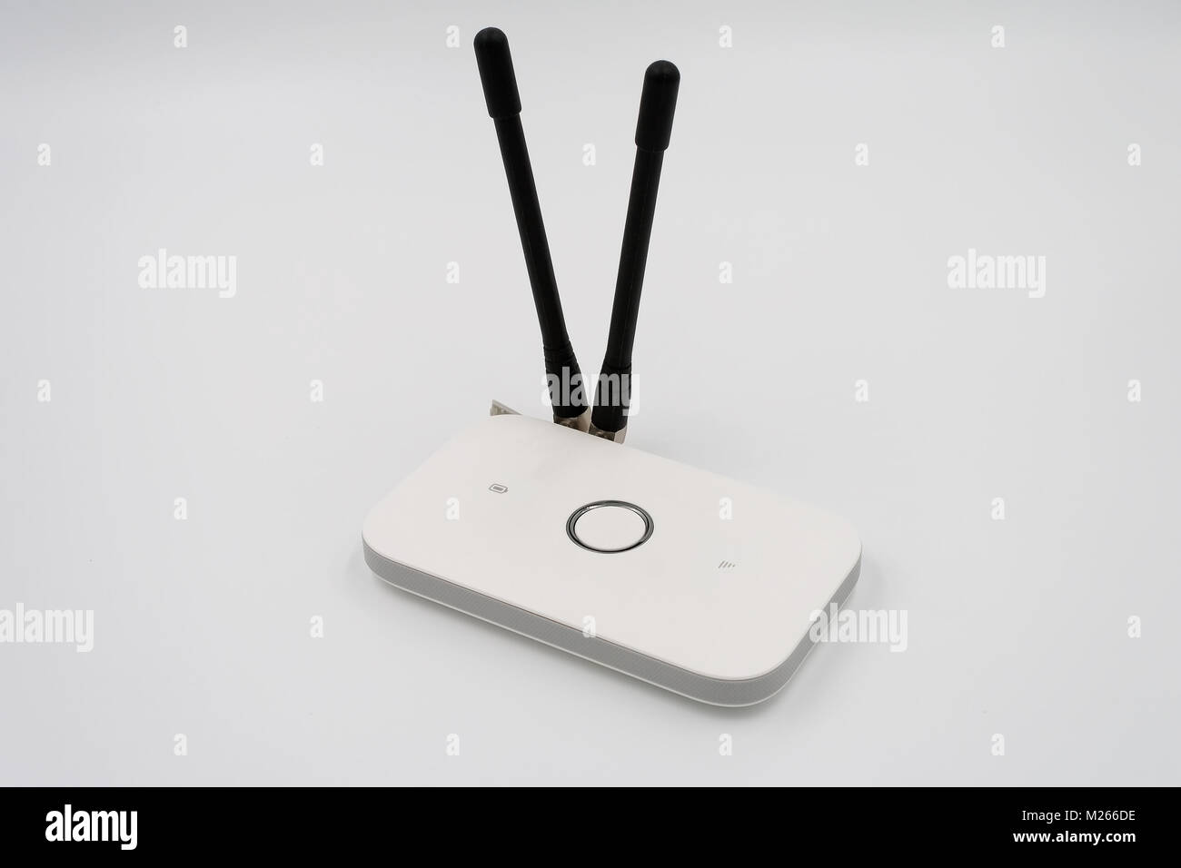 Wi-Fi portable router with connected external antennas. On a white ...