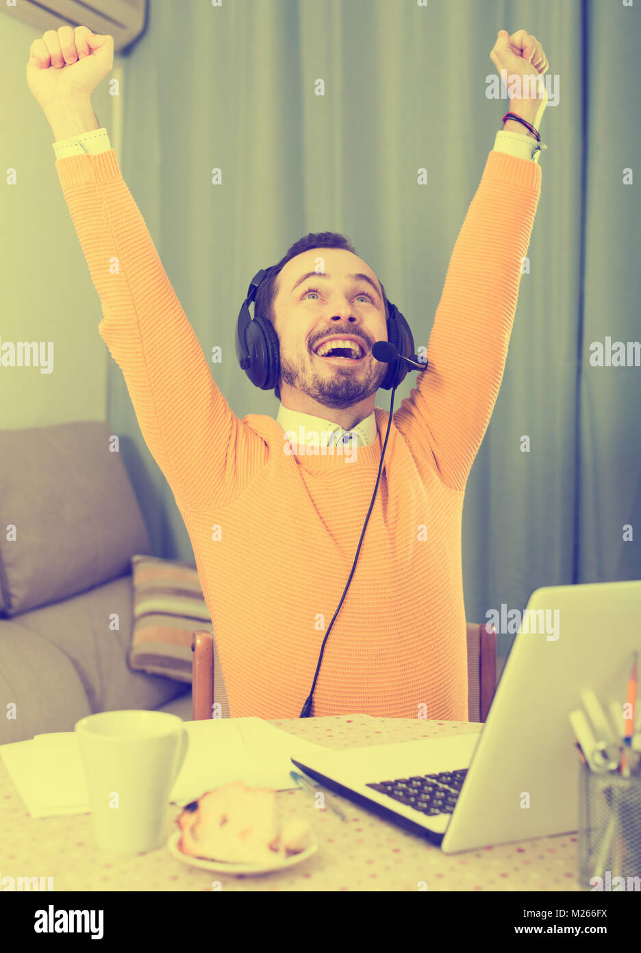Smiling man learner studying effectively at online courses at home ...