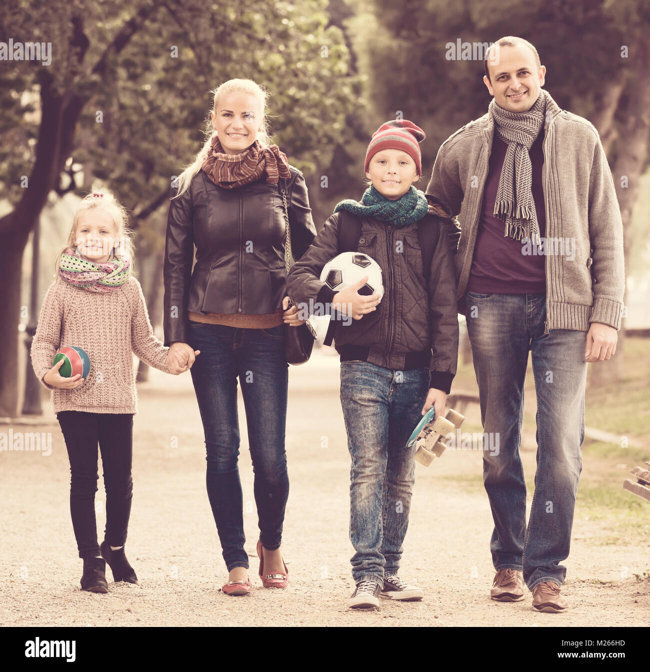 Joyful family with two children spending weekend together outdoors ...