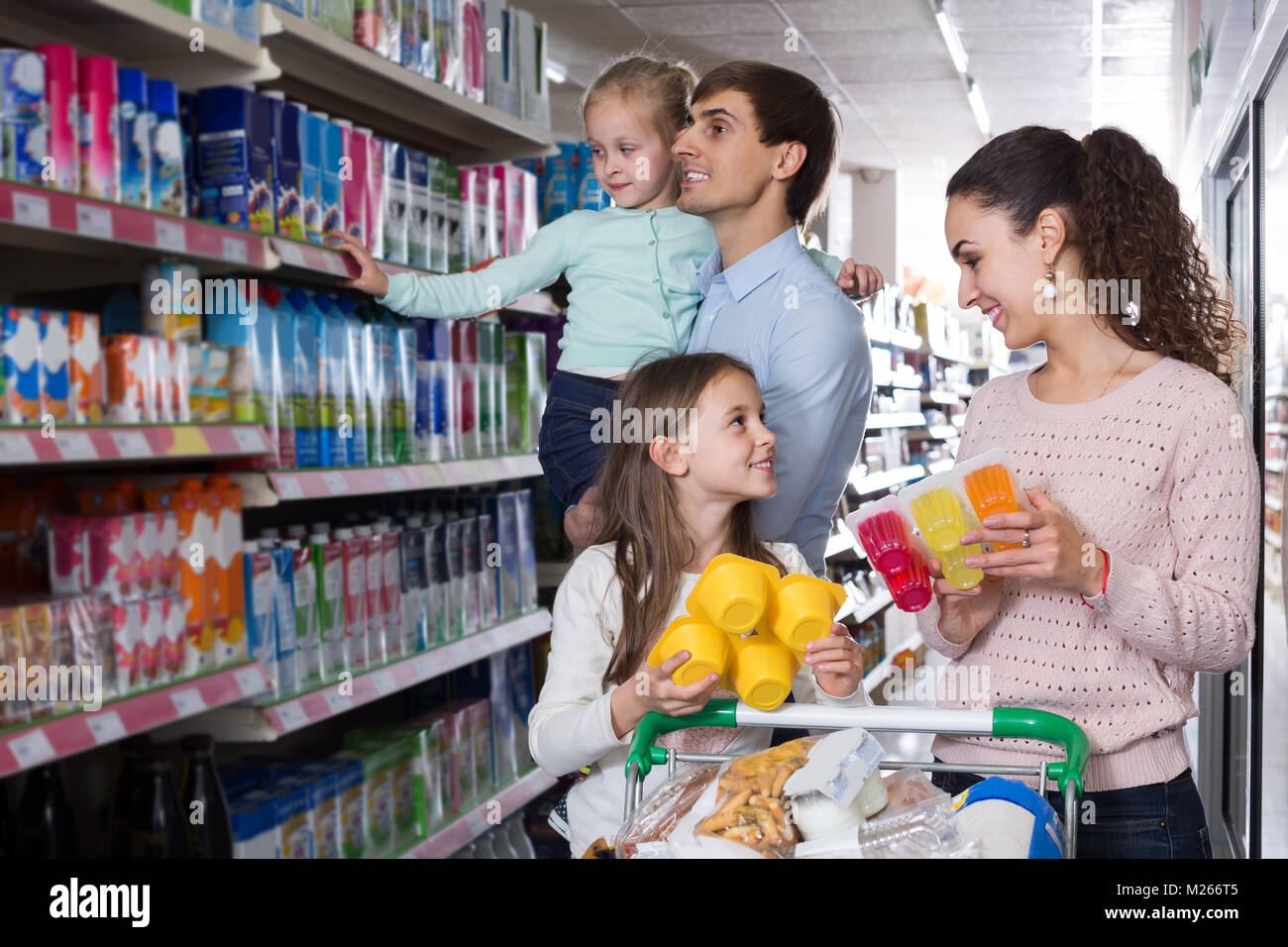 happy russian customers with children selecting sweet dairy products in ...