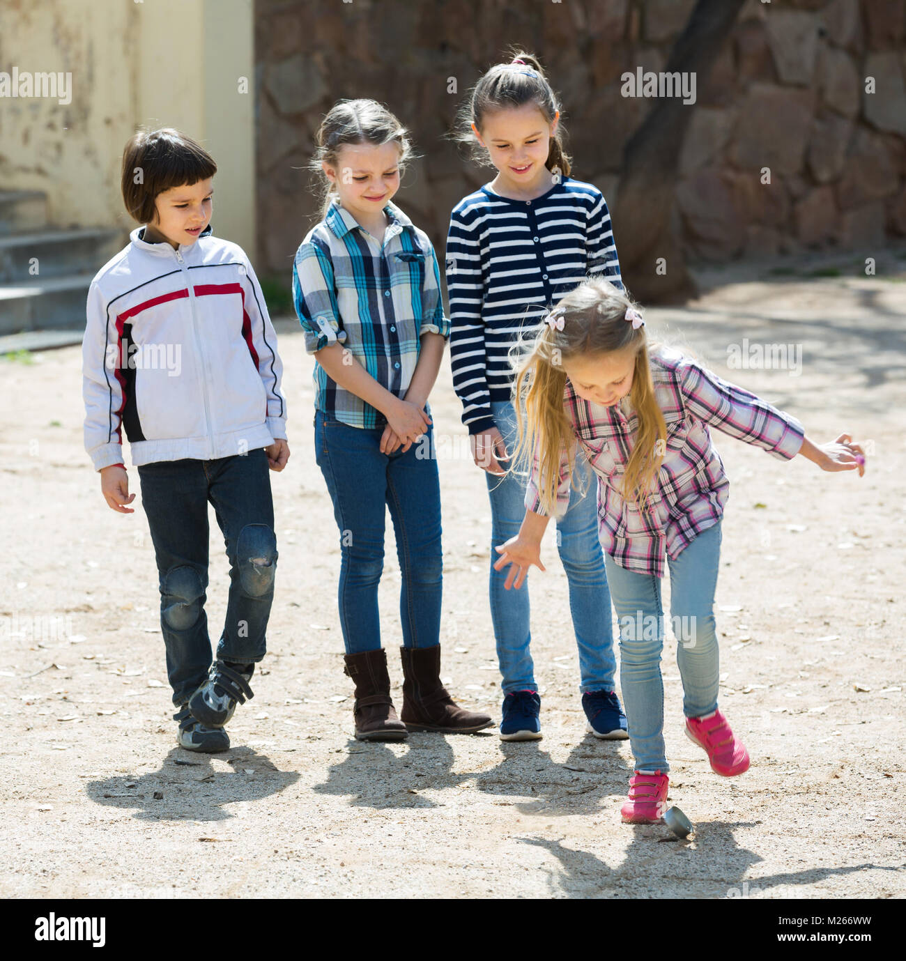 Children hopscotching and laughing in playground outdoors Stock Photo ...
