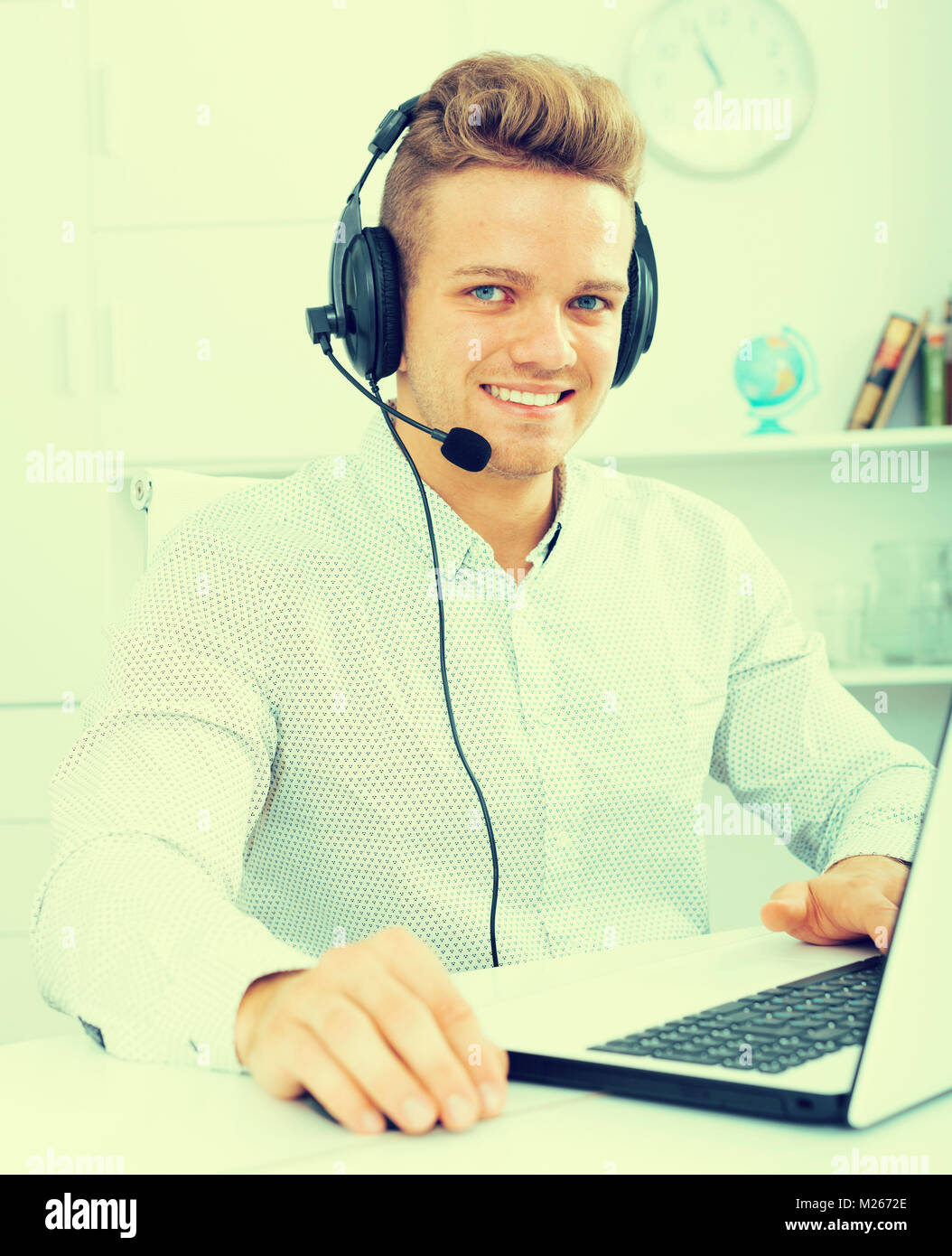 Positive call center male operator talking with client in agency Stock ...