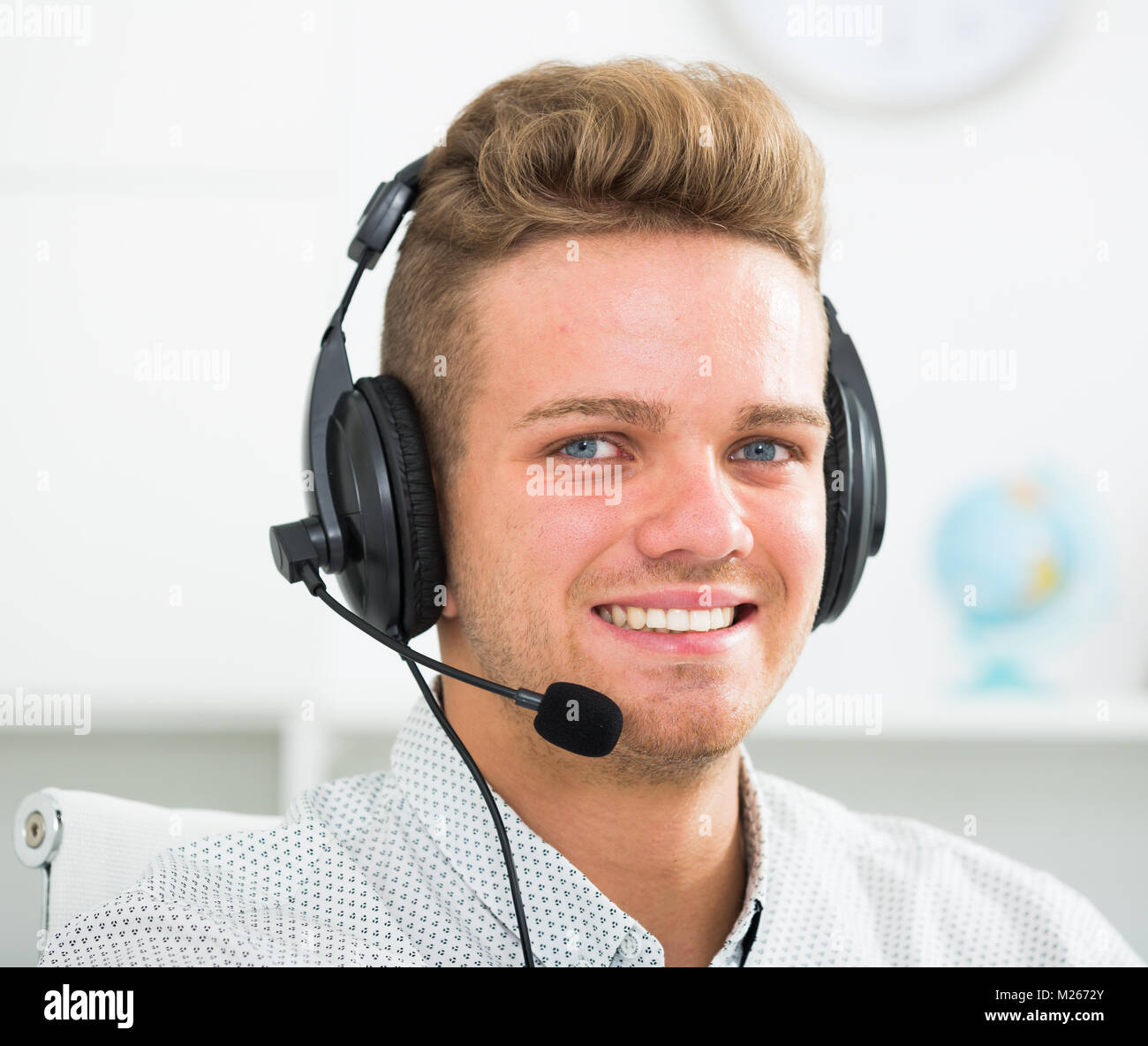 Portrait of young and successful call centre operator in office Stock ...