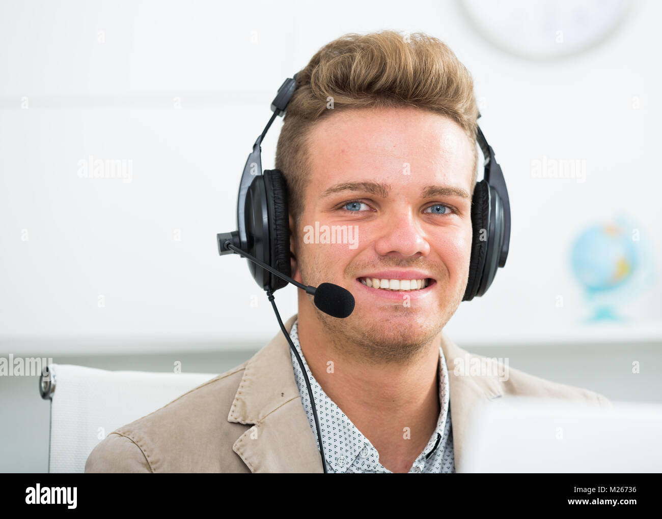 Portrait of male call centre operator working in modern office Stock ...