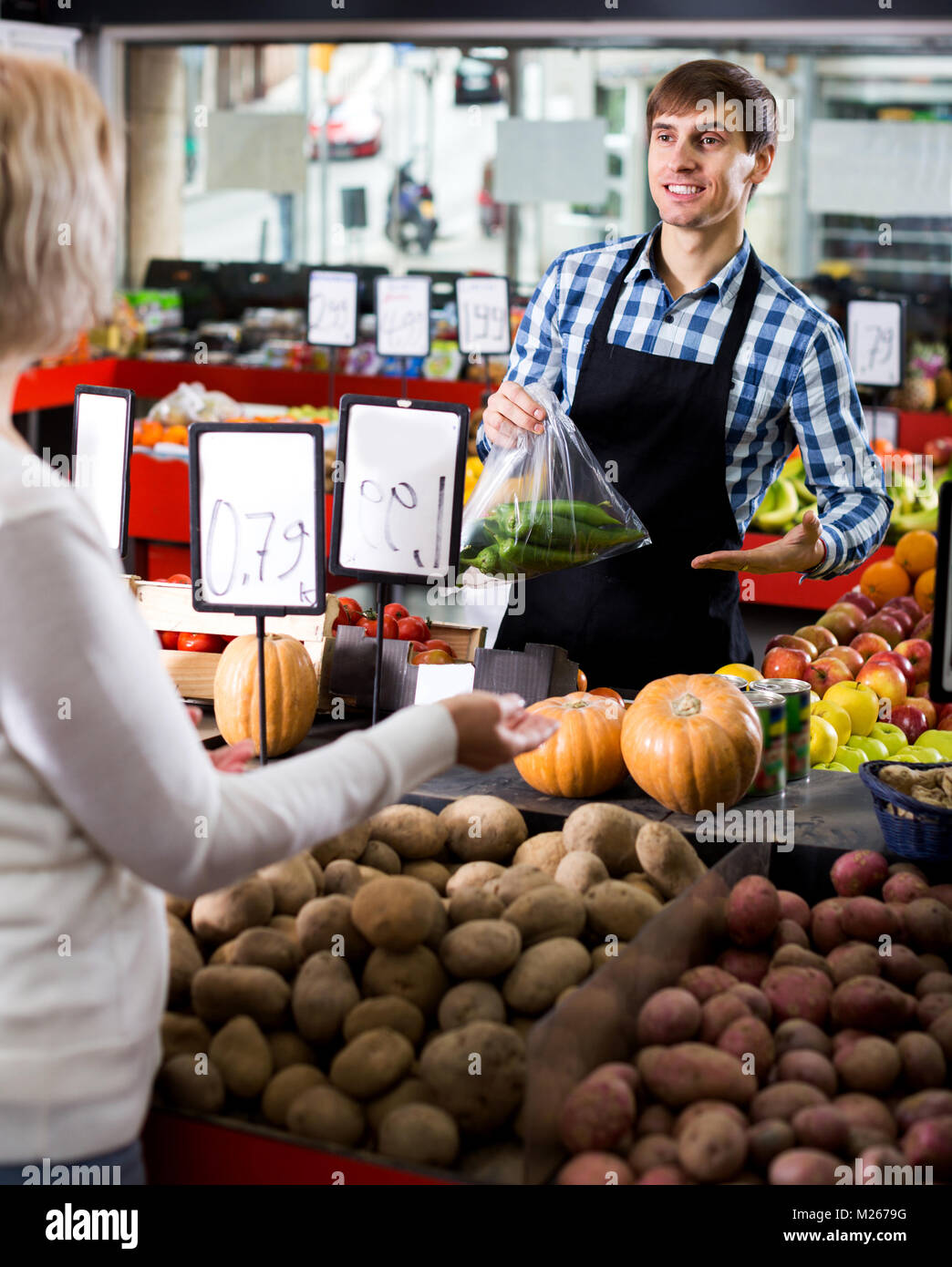 Portrait of senior customer and young seller in grocery Stock Photo - Alamy