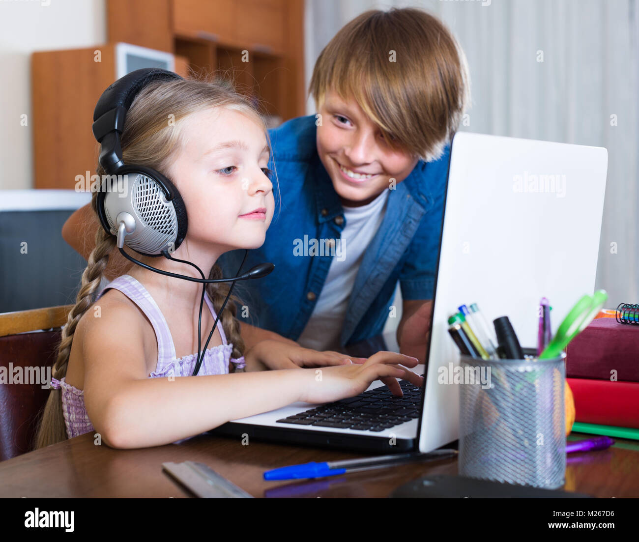 russian brother and sister playing game online on laptop Stock Photo ...