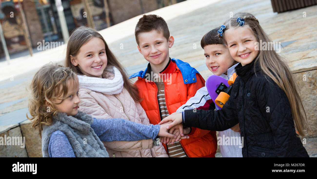 Positive happy children holding hands and giving friendship vow Stock ...