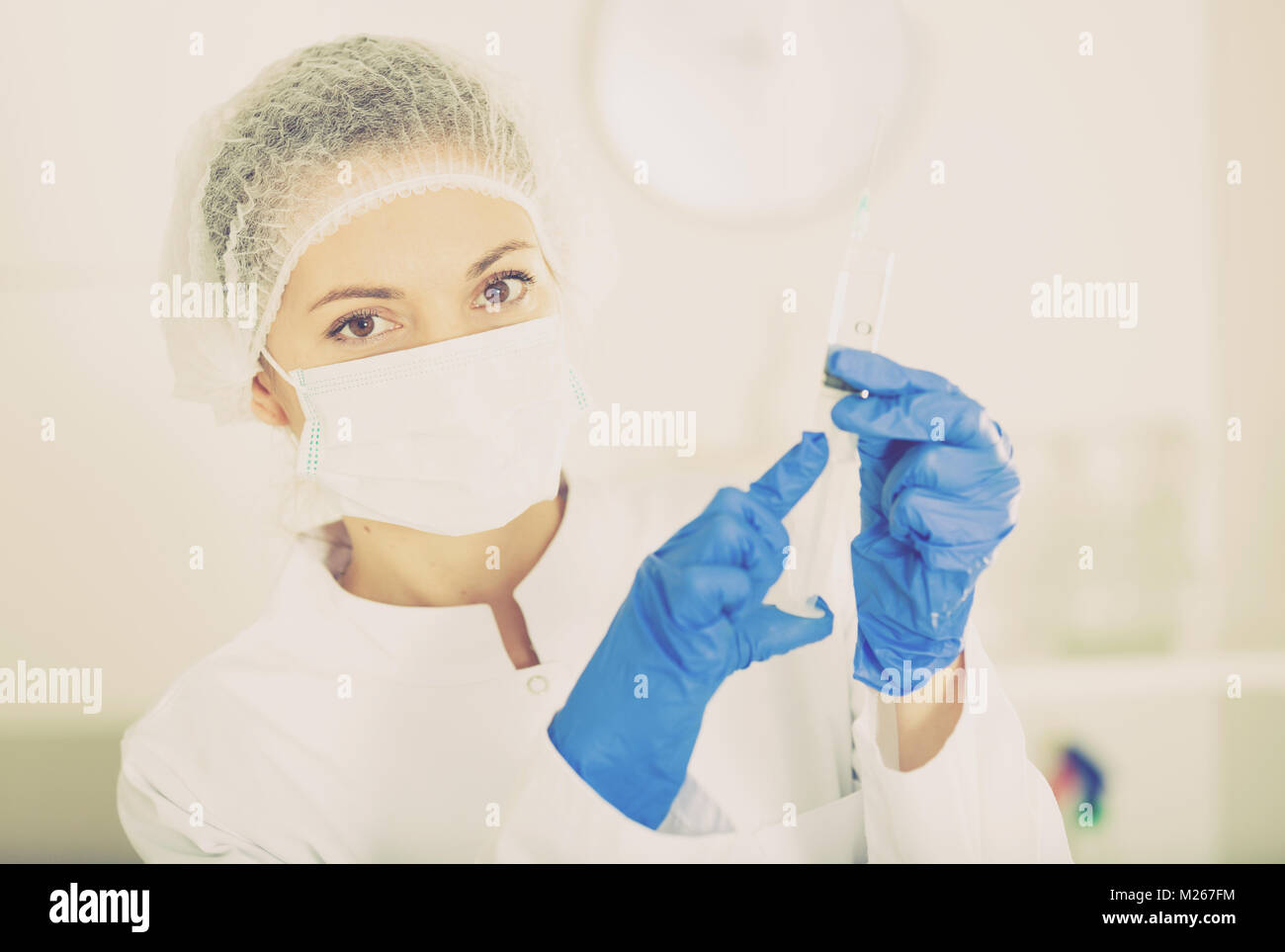 Young female nurse ready to make injection in hospital Stock Photo - Alamy