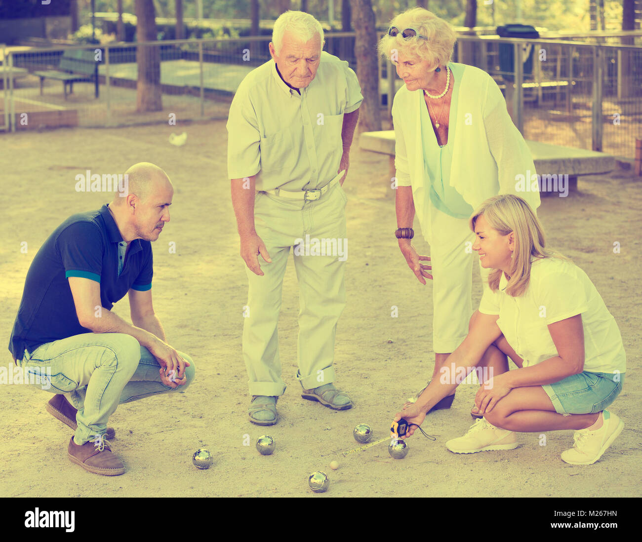 Happy family of two generations playing bocce at a garden Stock Photo ...