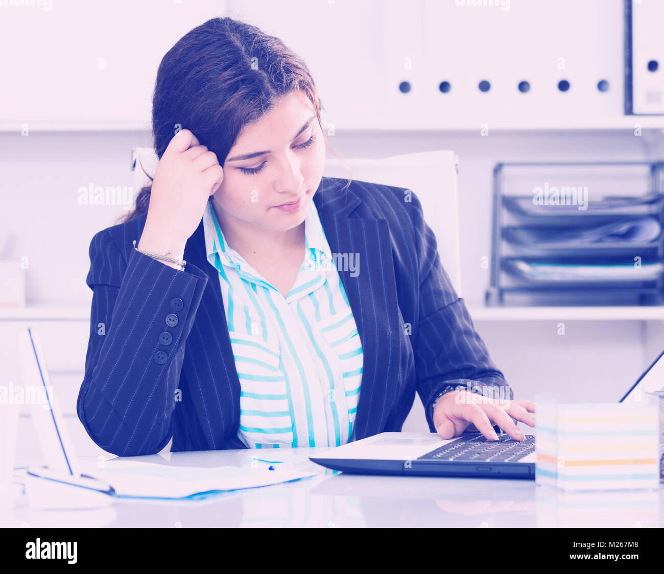 Woman is having complicated issue with project in office Stock Photo ...