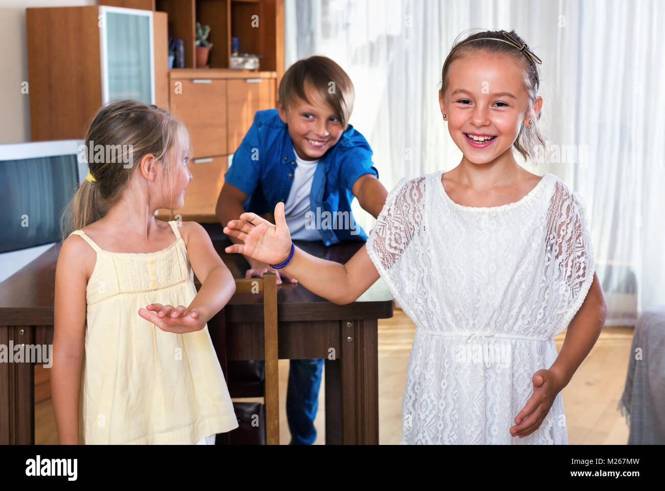 Joyful happy smiling child chasing other kids to tag or touch them ...