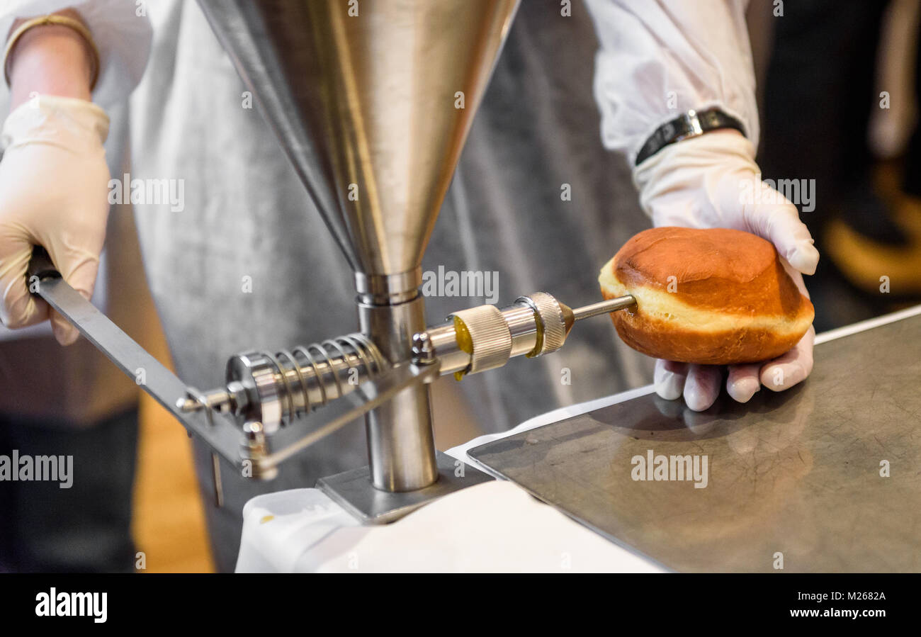 Making homemade jam doughnuts in a professional restaurant buffet ...