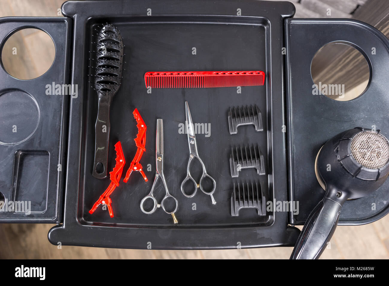 Professional hairdresser tools and hairdryer on a special stand in ...