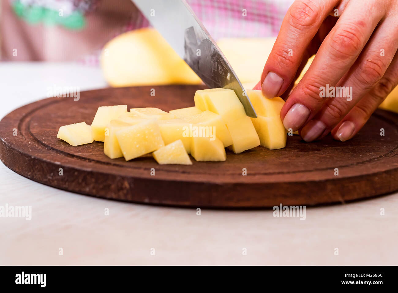 Woman slicing potatoes on wooden hi-res stock photography and images ...