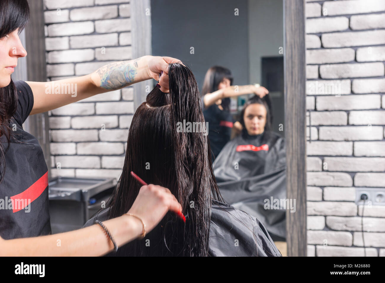 Woman parting hair in mirror hi-res stock photography and images - Alamy