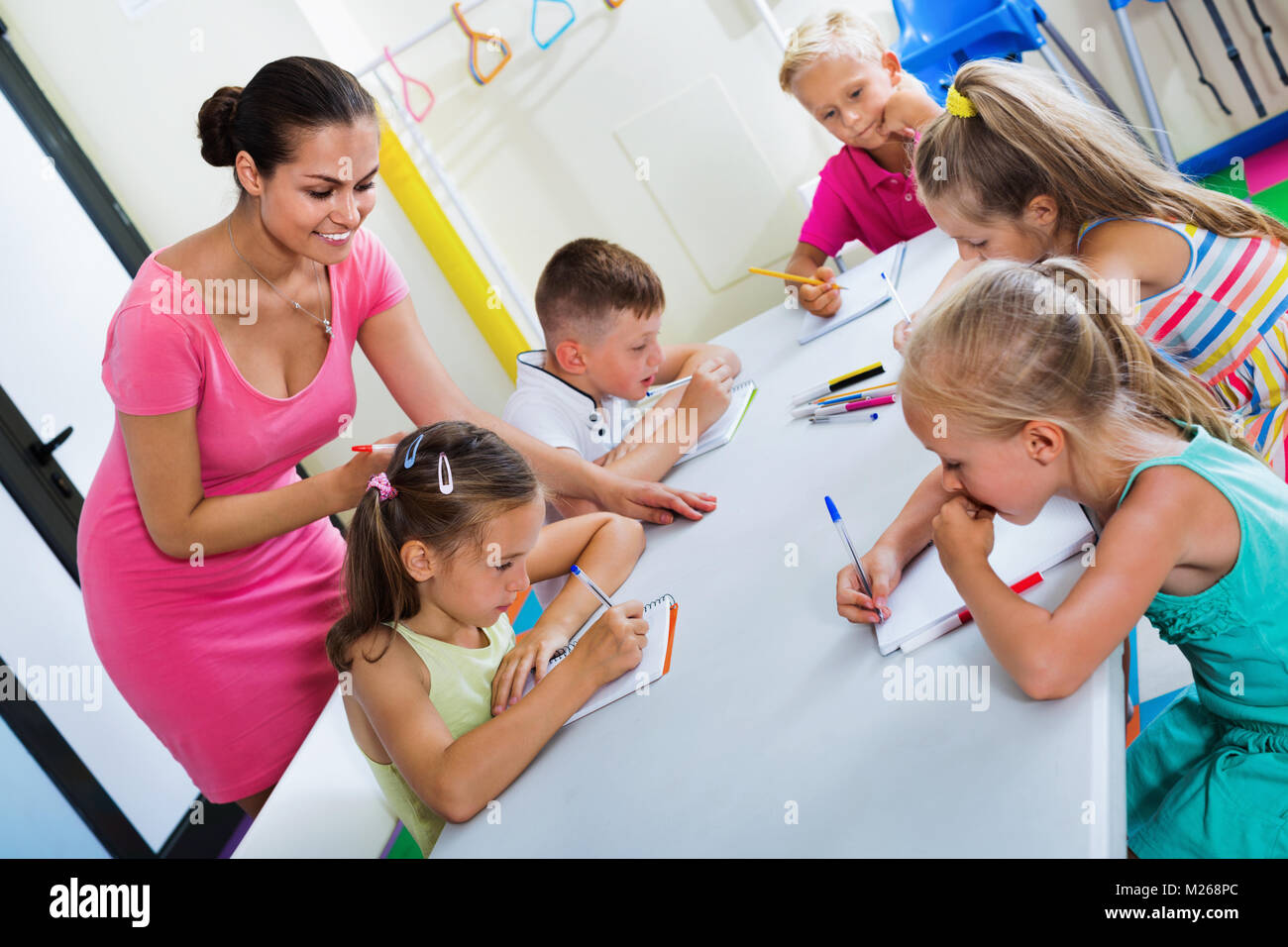 Diligent kids learning to write on lesson in elementary school class ...