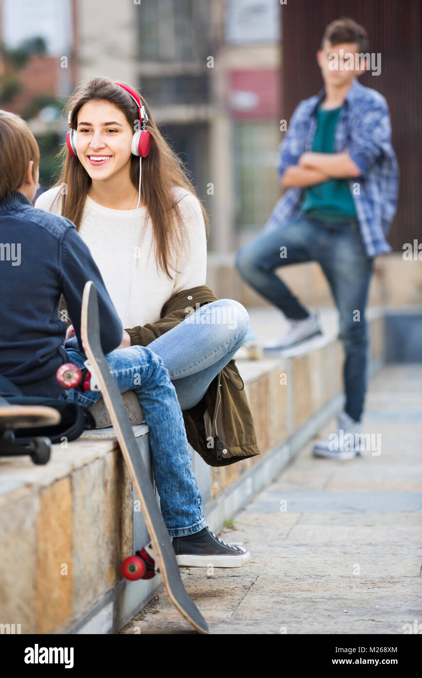 Jealous teen and his happy russian friends after conflict outdoors ...