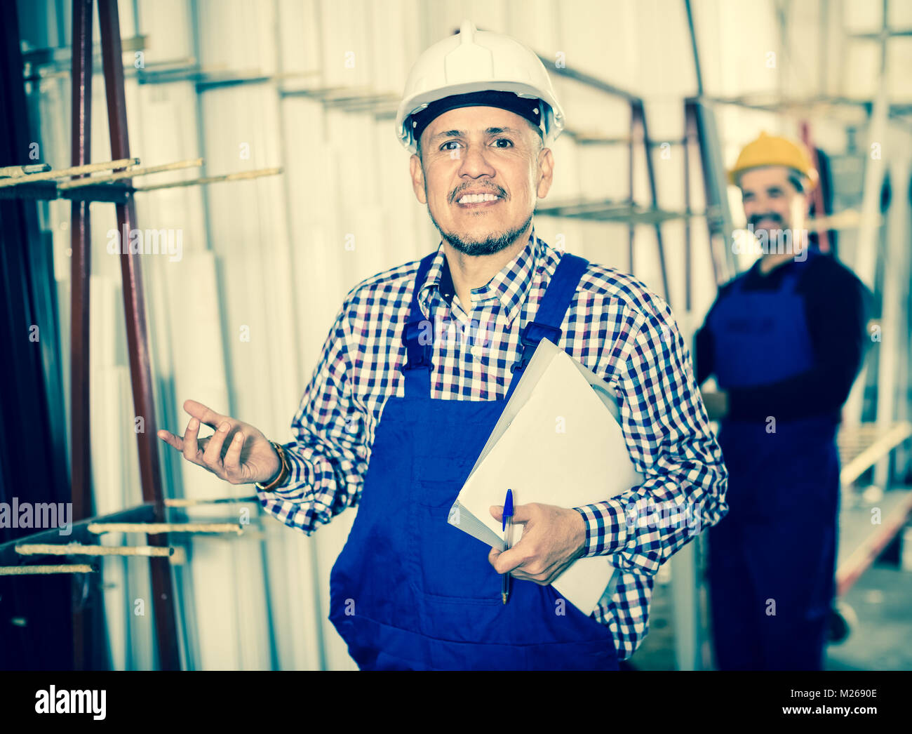 american controller in helmet with documents at workshop Stock Photo ...
