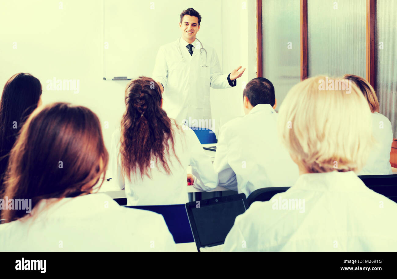Young multinational students and attractive professor having discussion ...