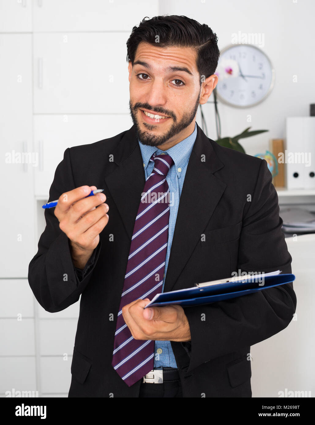 Adult male is signing financical papers at work place Stock Photo - Alamy