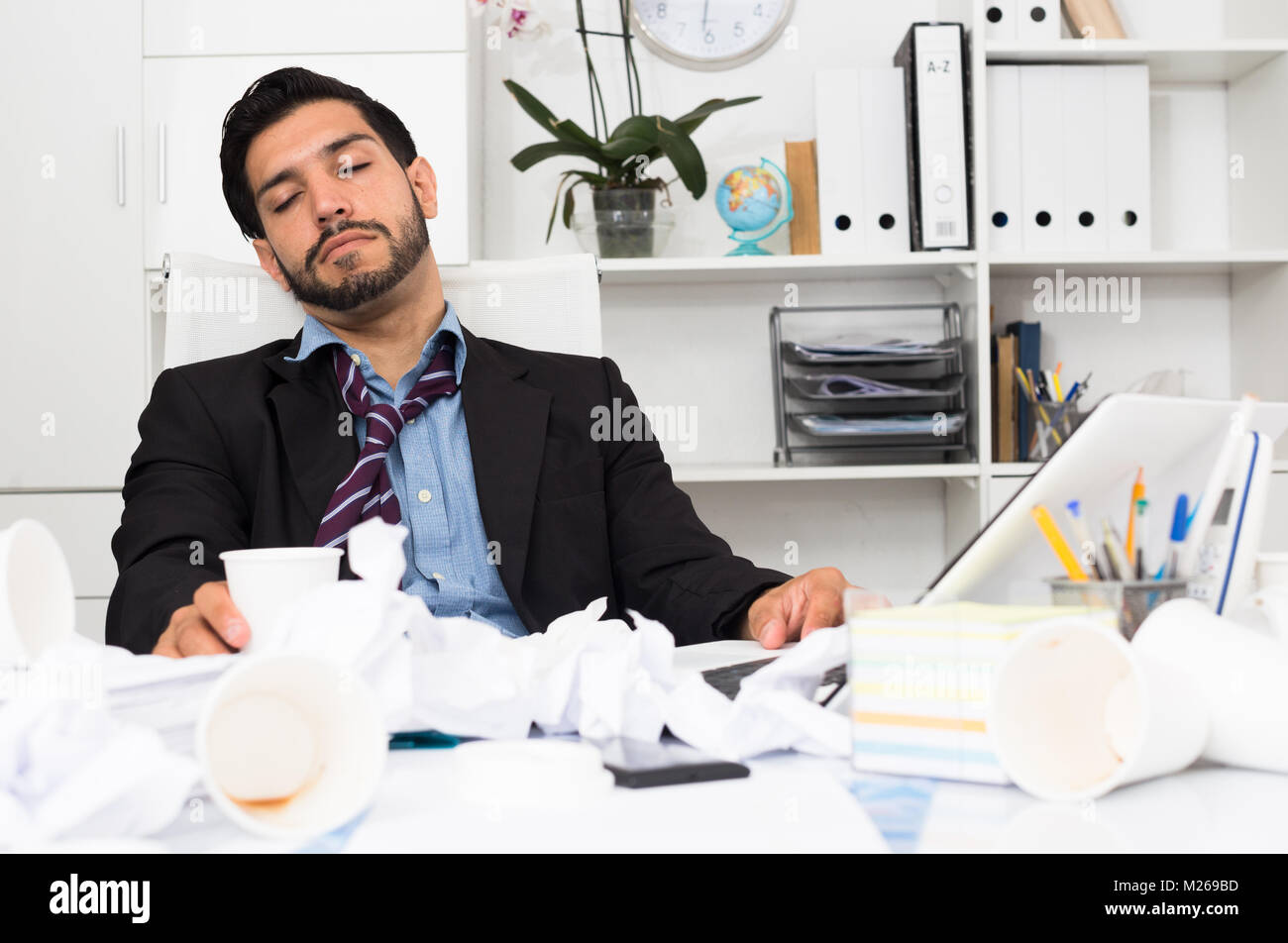 Businessman is resting after productive work day in office Stock Photo ...