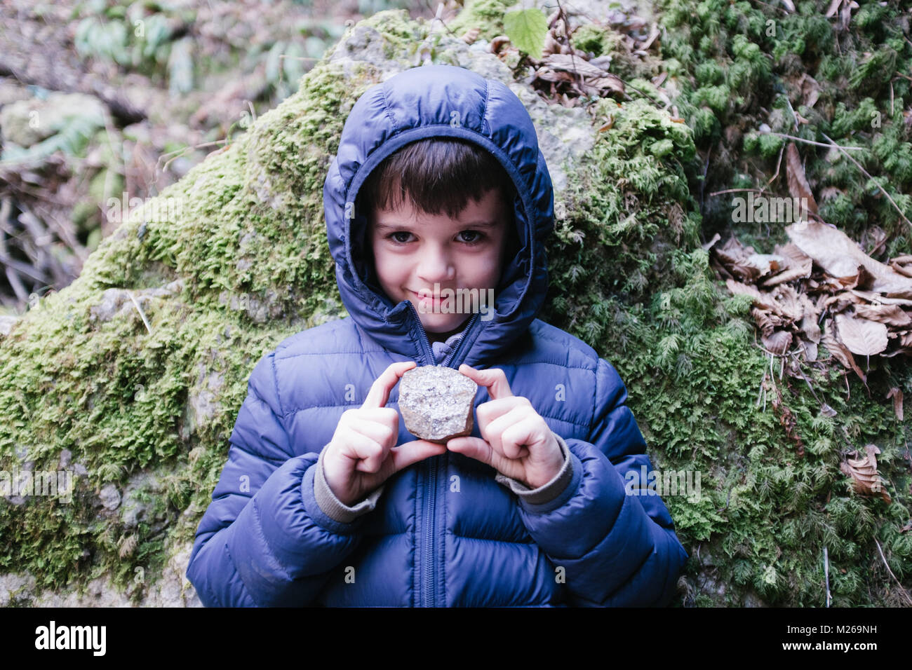 portrait of a child showing a stone in his hands Stock Photo - Alamy