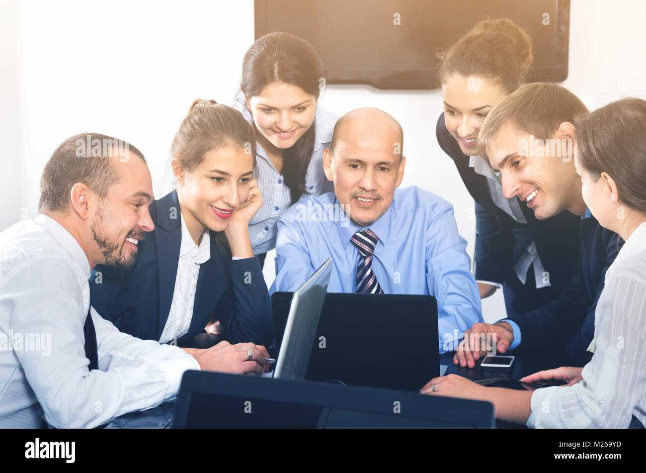 Glad cheerful positive working team sharing ideas on project during ...