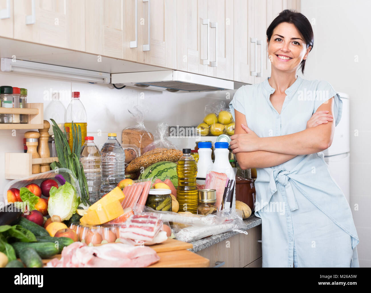 Portrait of cheerful american woman who is readying for cooking new ...