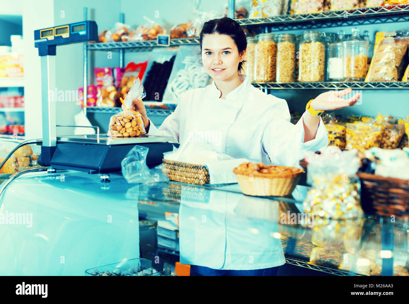 Friendly smiling woman selling cookies and other fillings Stock Photo ...